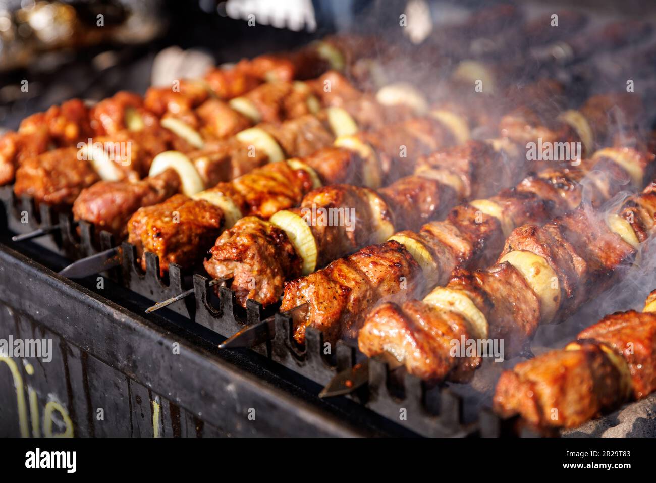 Bbq kebab grilling on open grill during street food festival Stock ...
