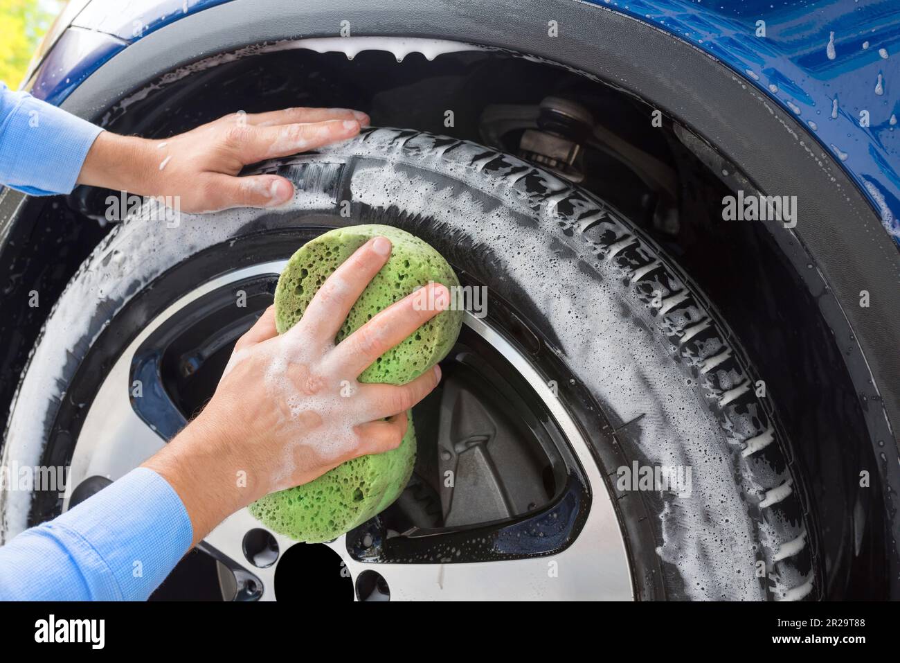 Man, washing the wheels of car on autowashing. Car washing Stock Photo ...