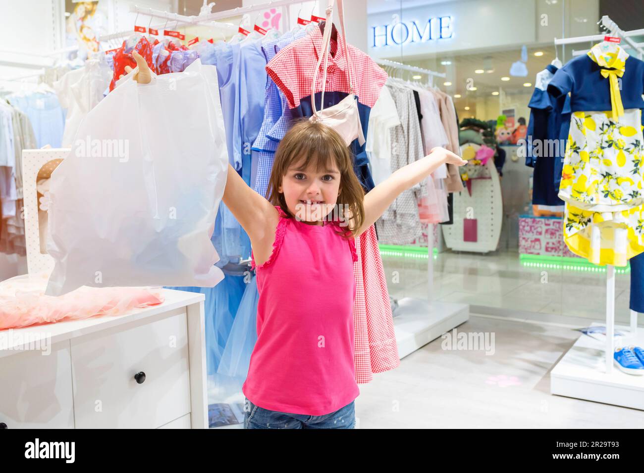 A happy little girl shopping at the discount store Stock Photo - Alamy
