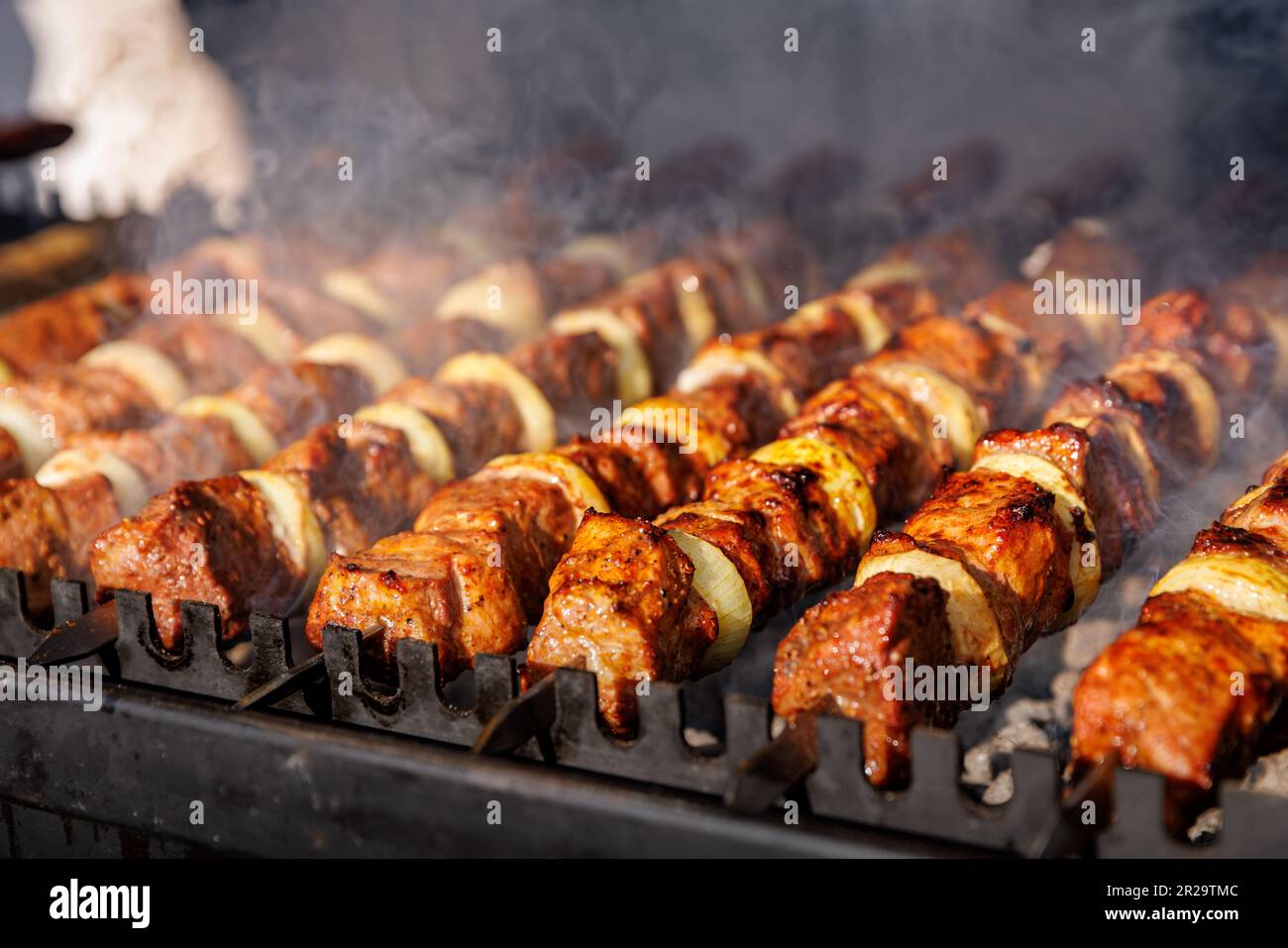 Bbq kebab grilling on open grill during street food festival Stock ...