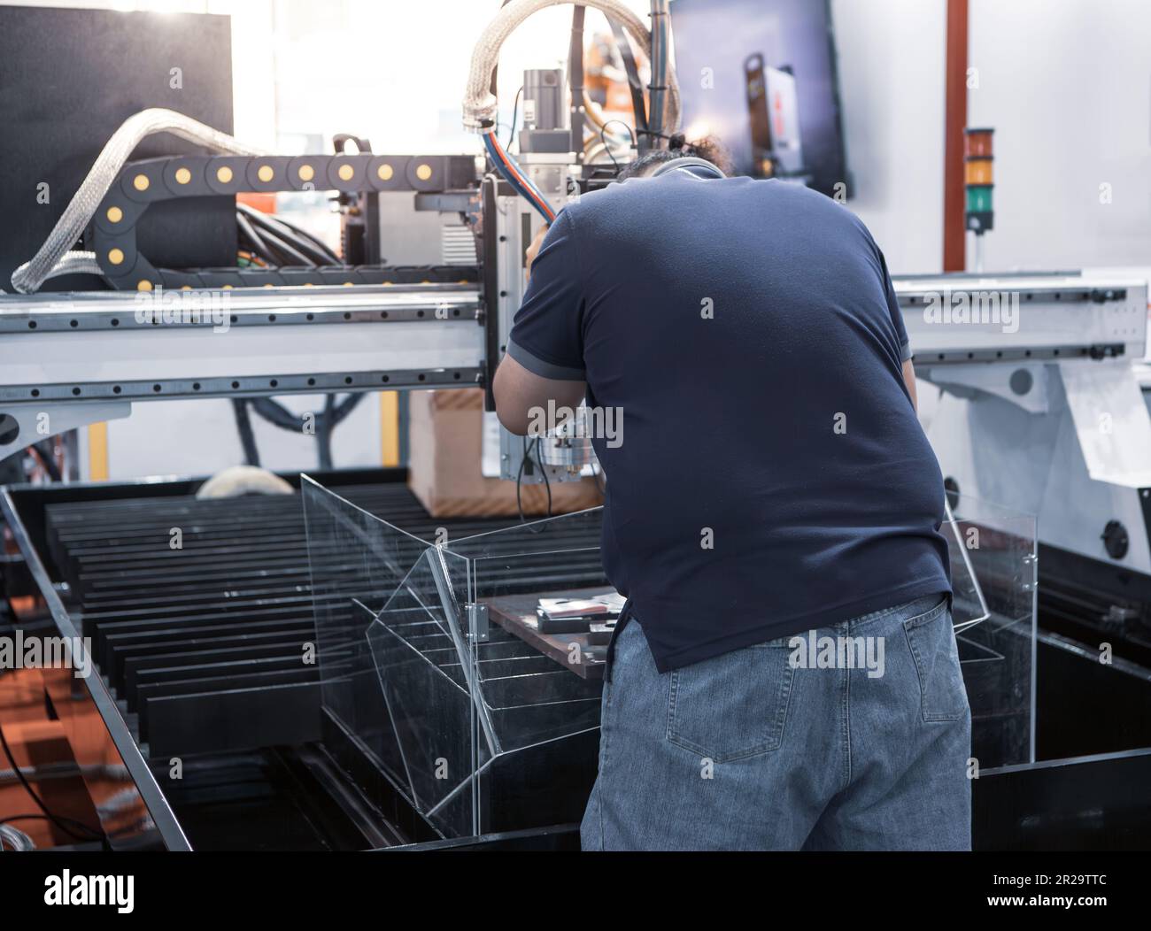 Industrial worker operate CNC fiber laser cutting machine. Industrial ...