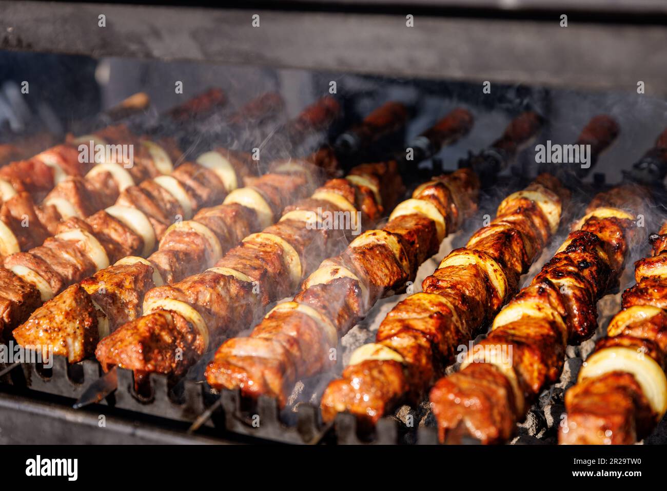 Bbq kebab grilling on open grill during street food festival Stock ...