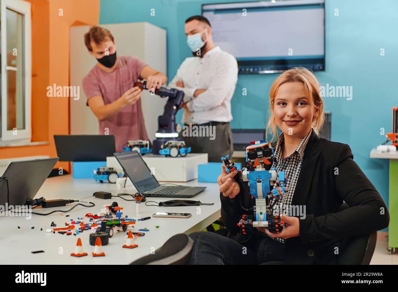 A woman sitting in a laboratory and solving problems and analyzing the ...