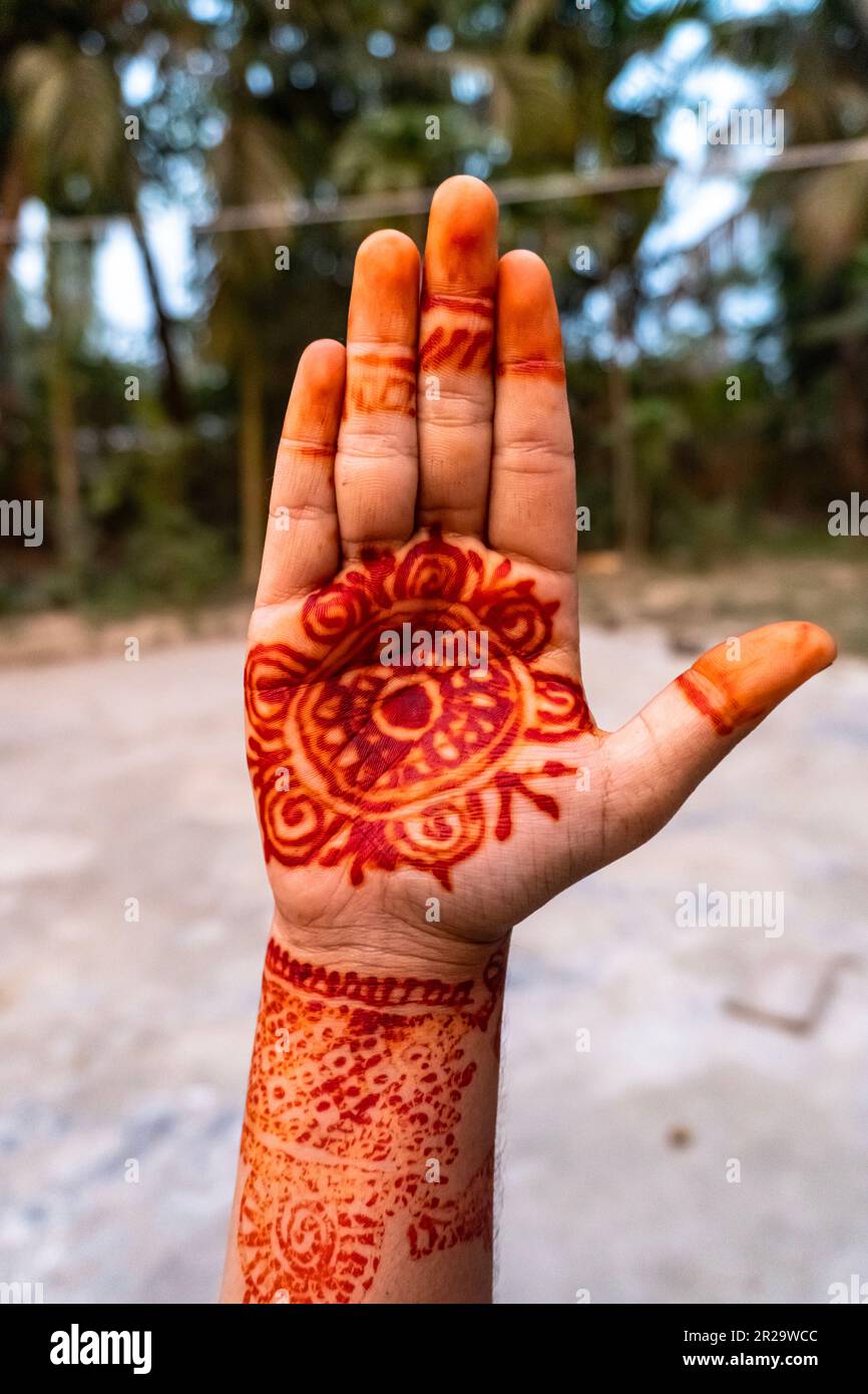 Portrait view of drawn mehndi on the hand of beautiful Bangladeshi girl ...