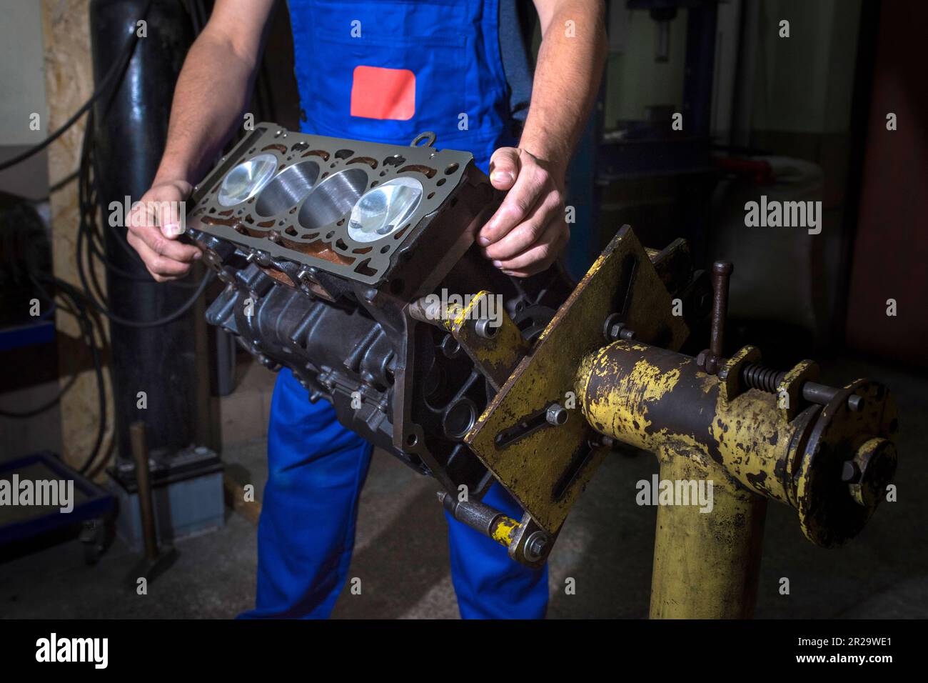 Auto mechanic working on a car engine in a garage. Repair service Stock ...