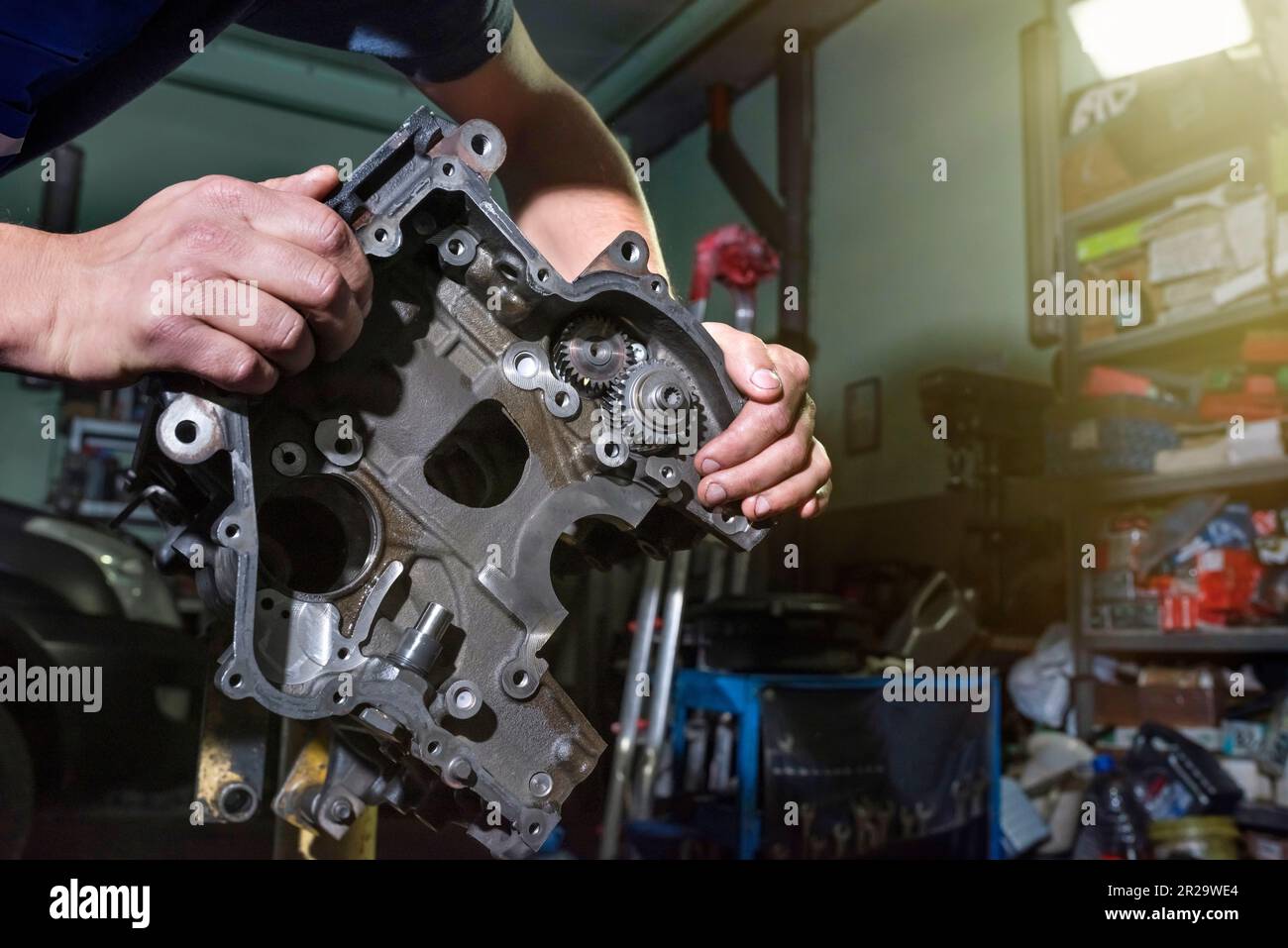 Auto mechanic working in a garage. Car engine part close-up Stock Photo ...