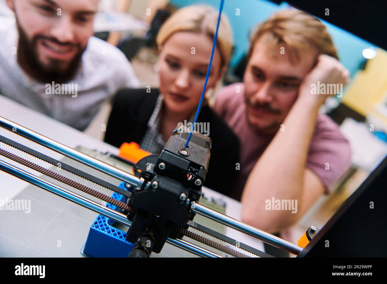 A group of colleagues working together in a robotics laboratory ...