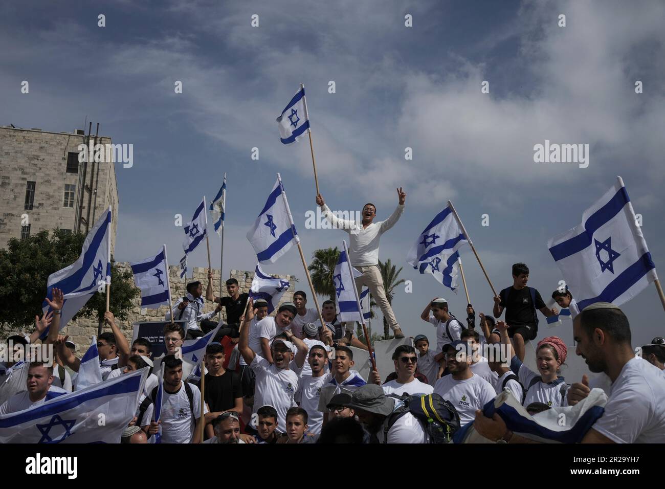Israelis wave national flags during a march marking Jerusalem Day, just ...