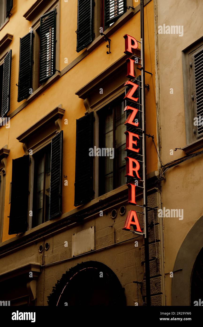 Signboard of a traditional Italian pizzeria on a narrow street in the ...