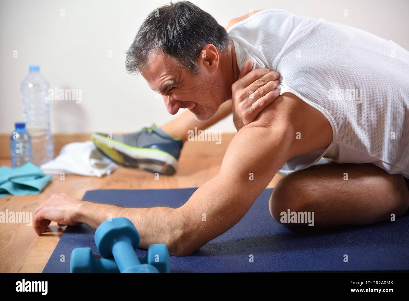 Detail of man doing sports with clavicle pain holding himself with his ...