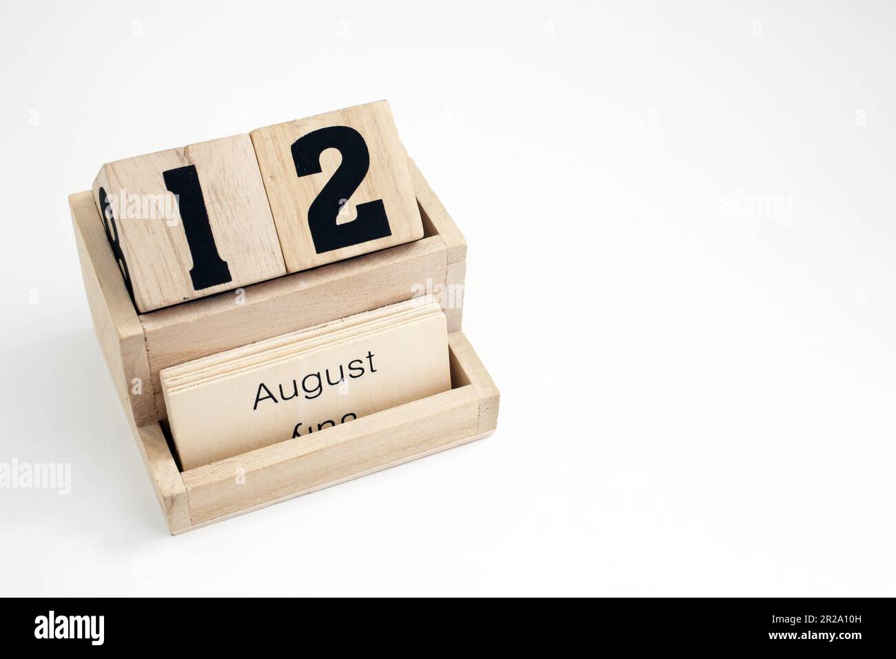 Wooden perpetual calendar showing the 12th of August Stock Photo - Alamy
