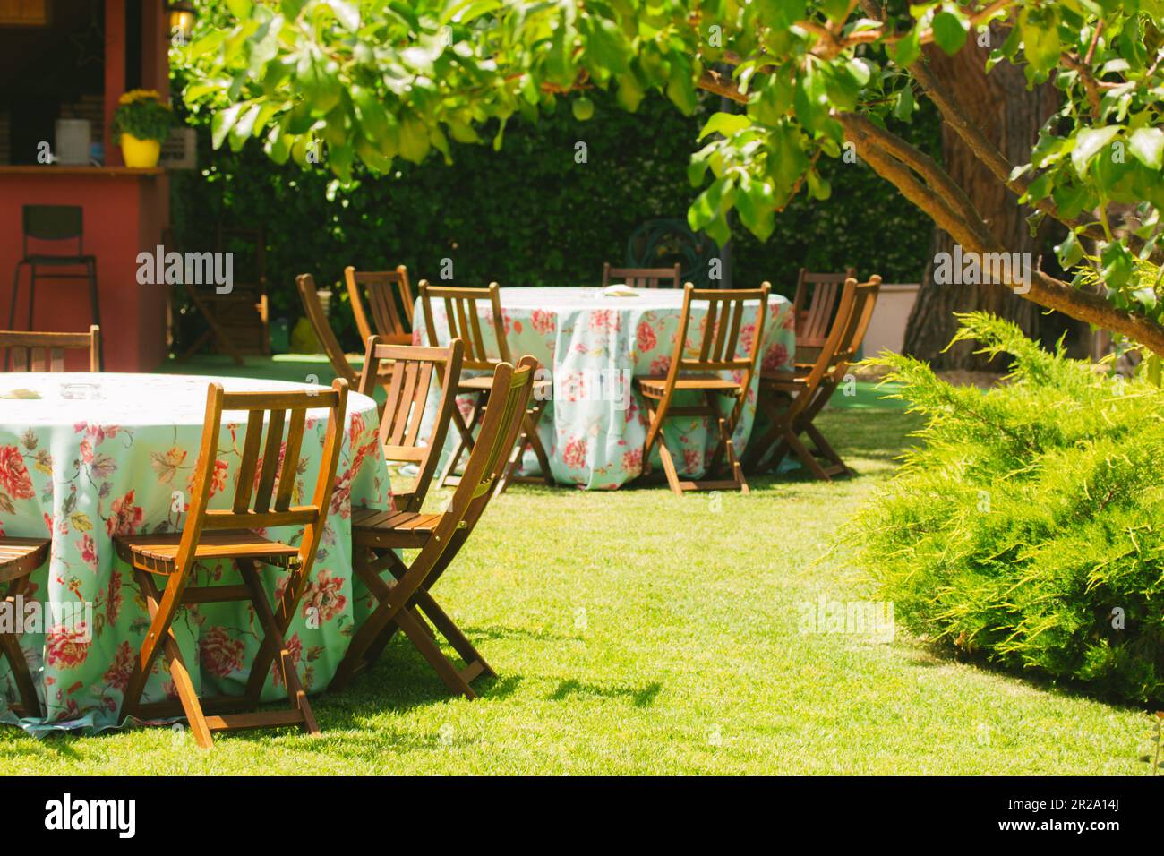 Beautifully set tables with floral tablecloths. Private backyard party ...