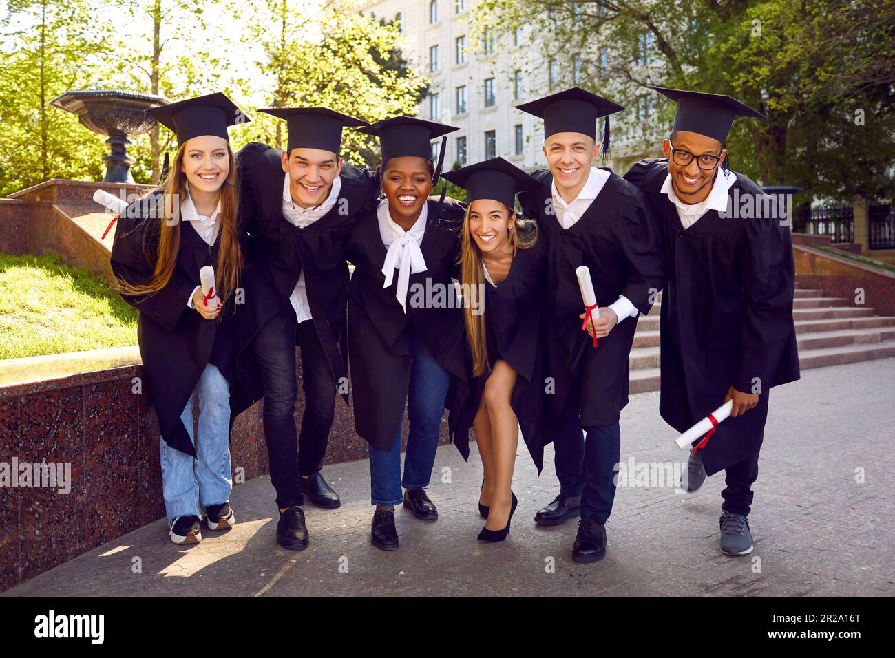Group of students pose cheerfully for graduation photo Stock Photo - Alamy