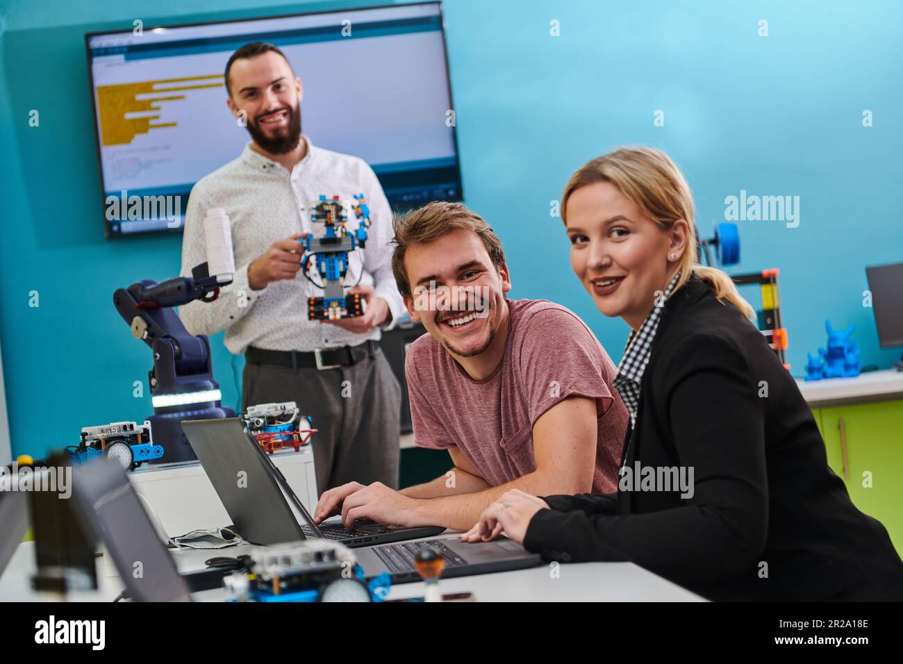 A group of colleagues working together in a robotics laboratory ...