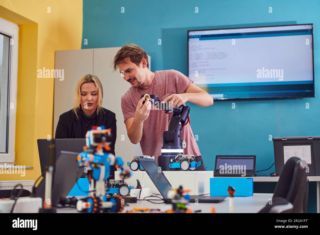 A group of colleagues working together in a robotics laboratory ...