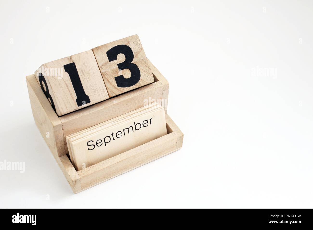 Wooden perpetual calendar showing the 13th of September Stock Photo - Alamy
