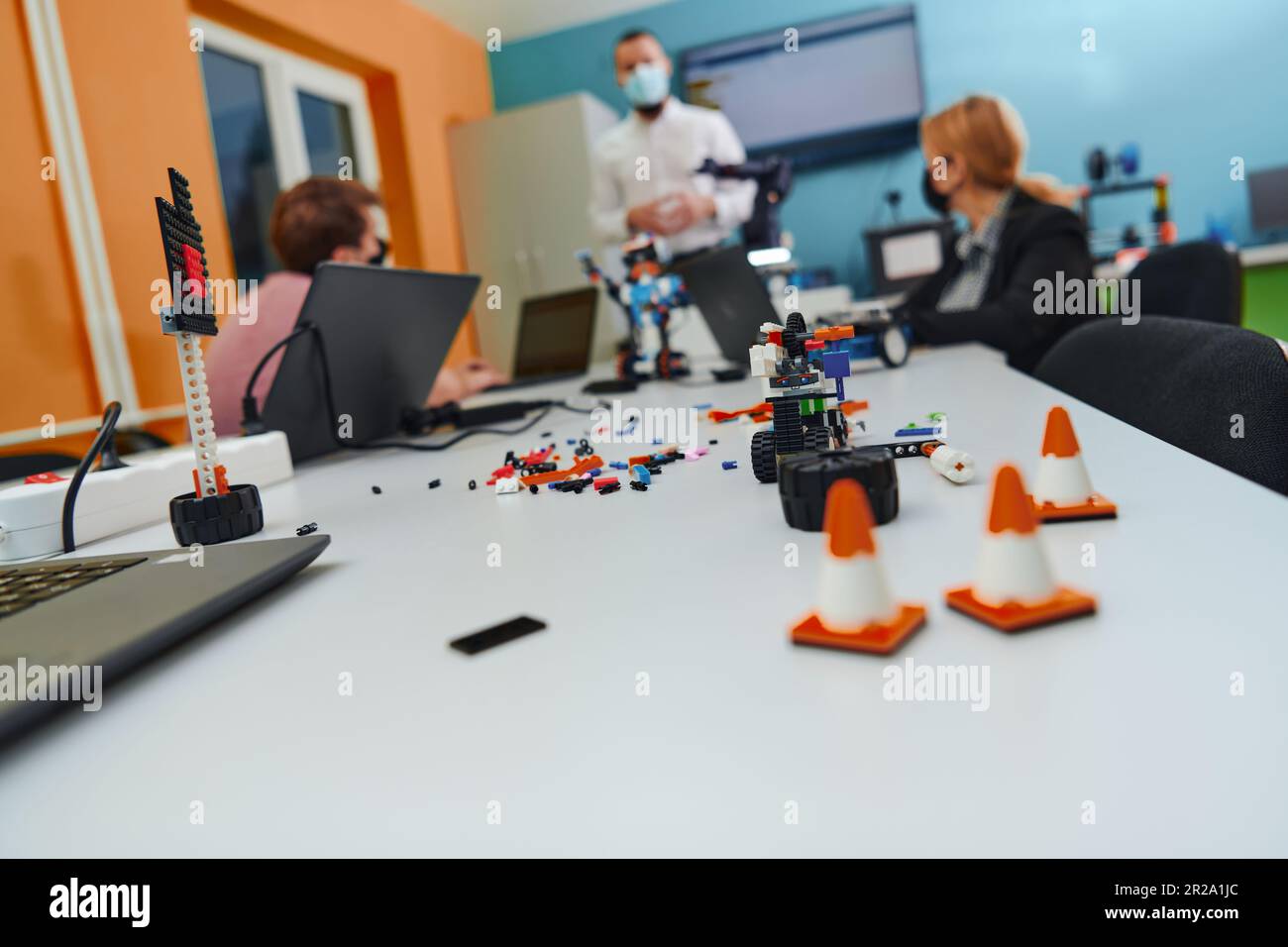 A group of colleagues working together in a robotics laboratory ...