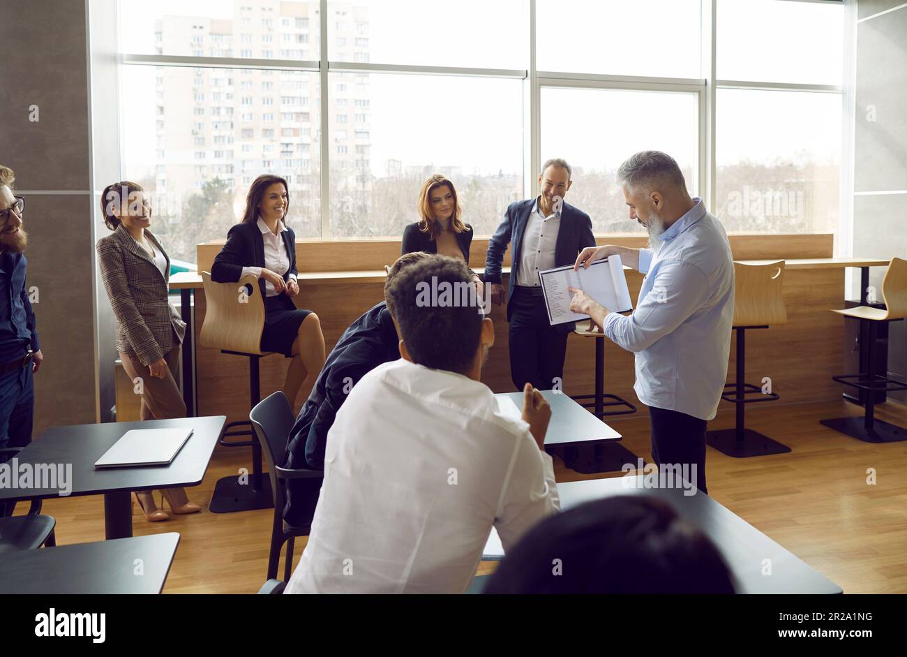 Professional business coach giving training workshop to group of people ...