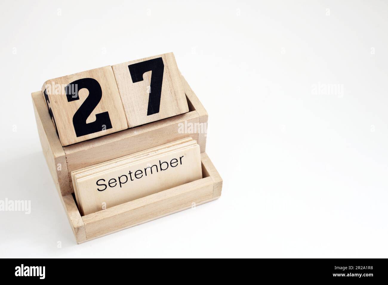 Wooden perpetual calendar showing the 27th of September Stock Photo - Alamy