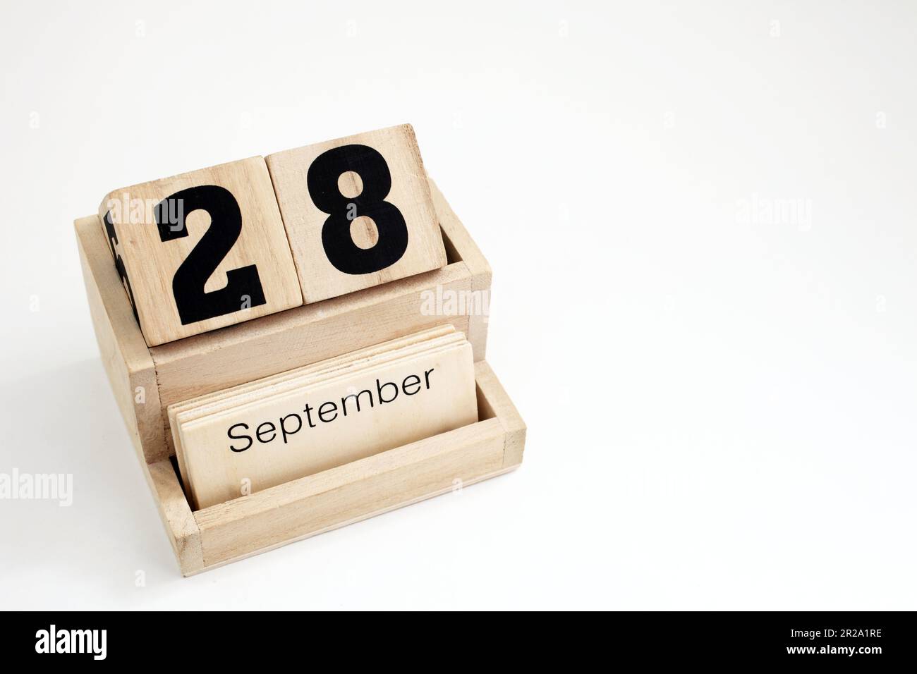 Wooden perpetual calendar showing the 28th of September Stock Photo - Alamy