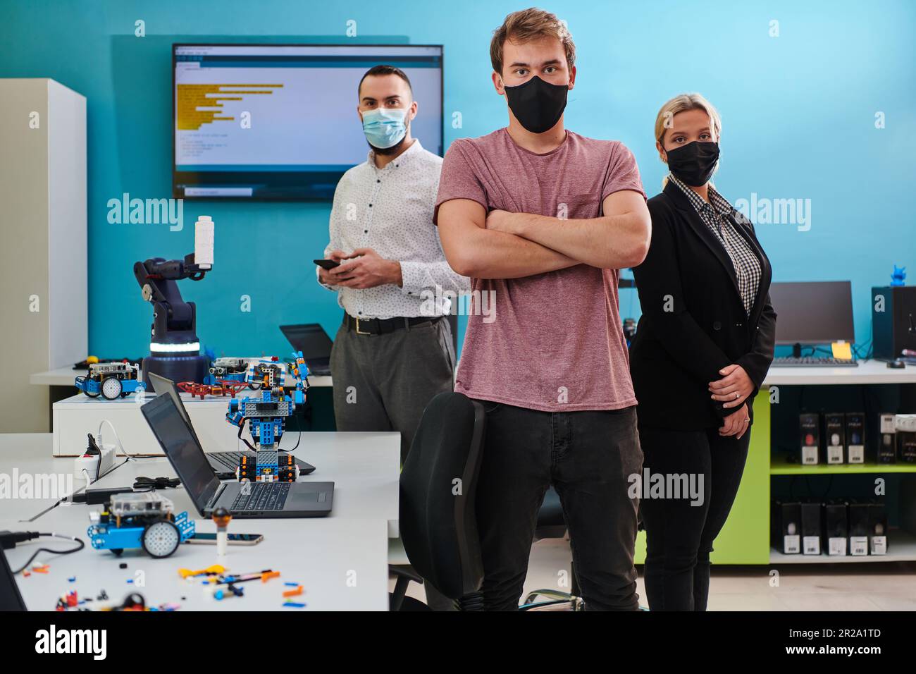 A group of colleagues working together in a robotics laboratory ...