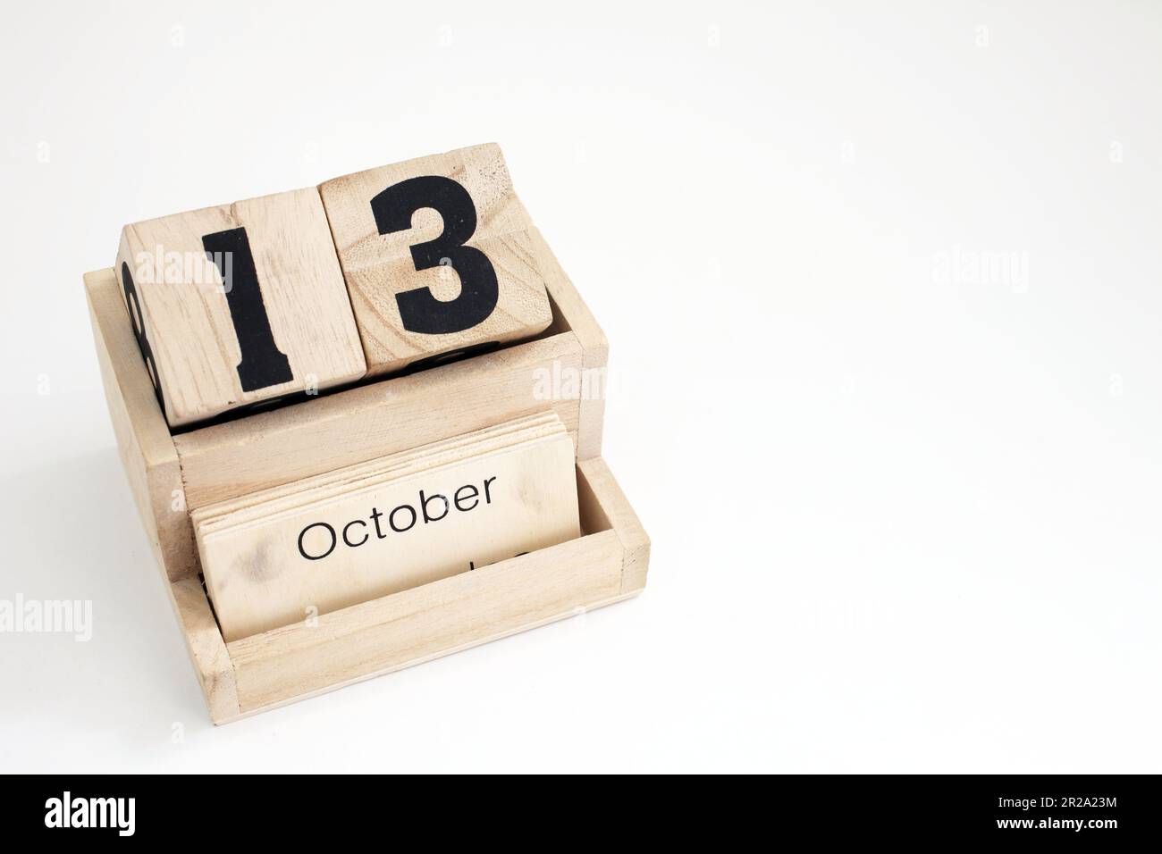 Wooden perpetual calendar showing the 13th of October Stock Photo - Alamy
