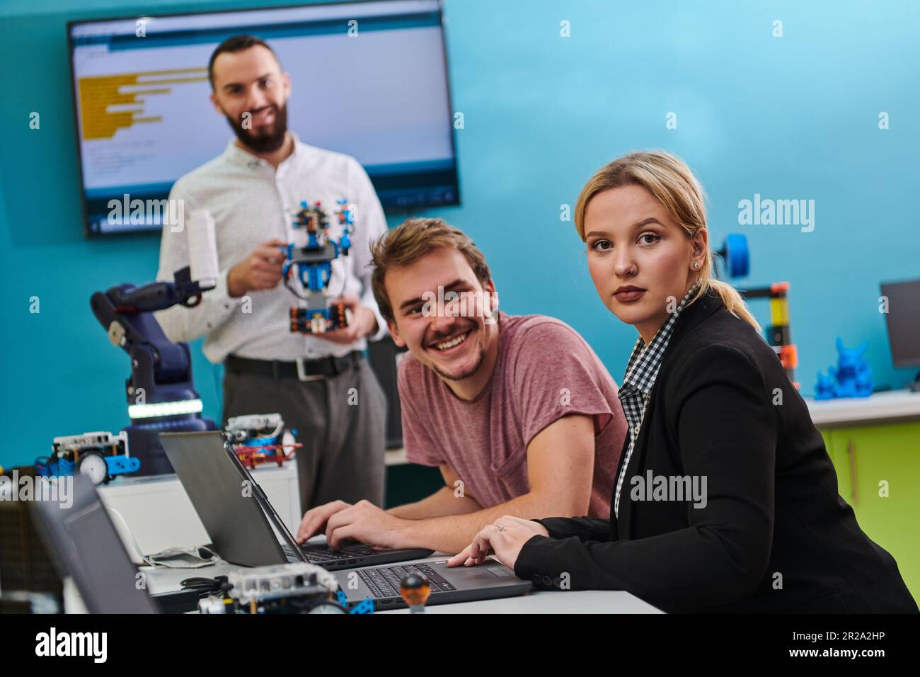 A group of colleagues working together in a robotics laboratory ...