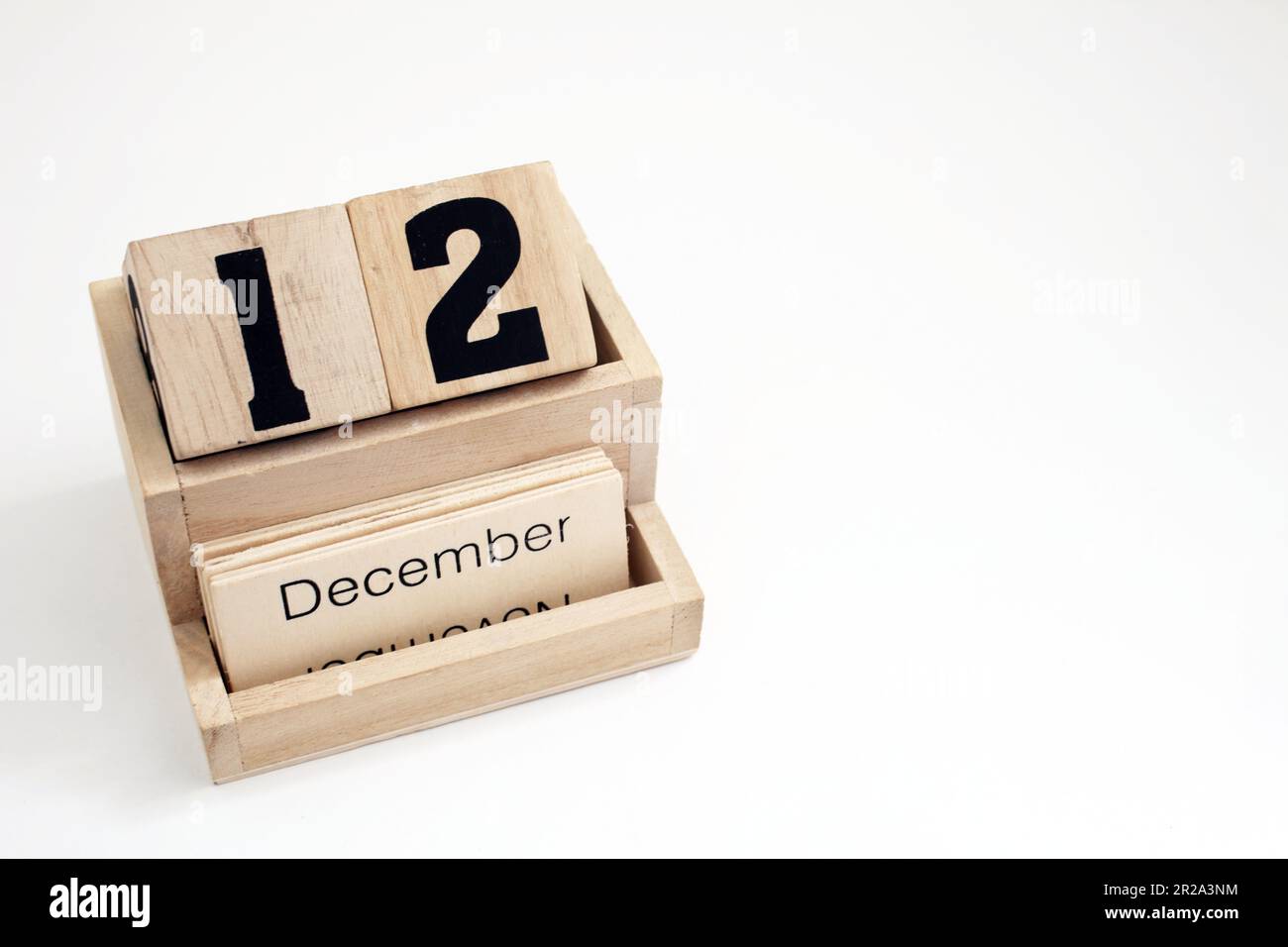 Wooden perpetual calendar showing the 12th of December Stock Photo - Alamy