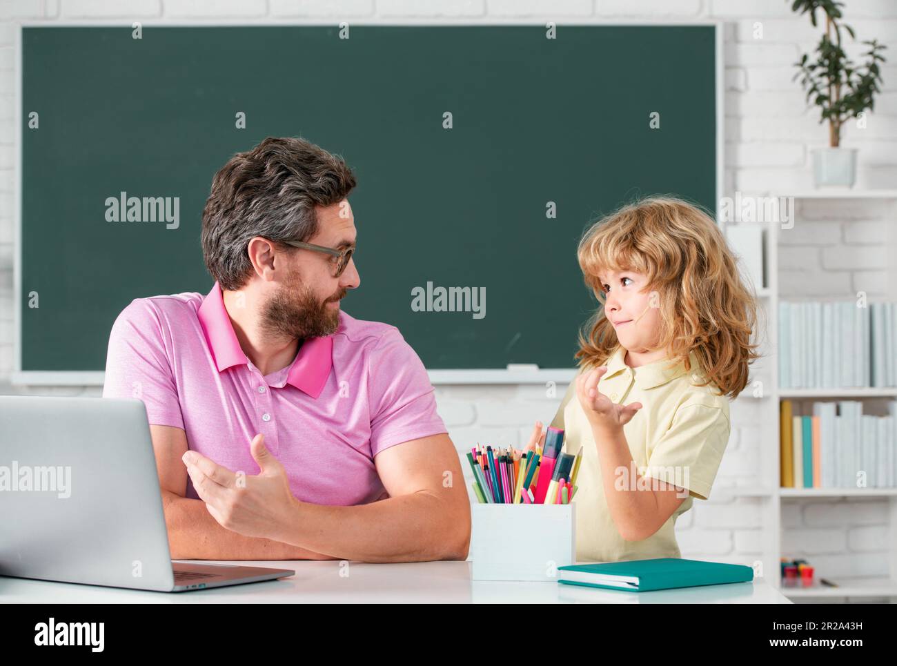 Teacher and child from elementary school learning at classroom Stock ...