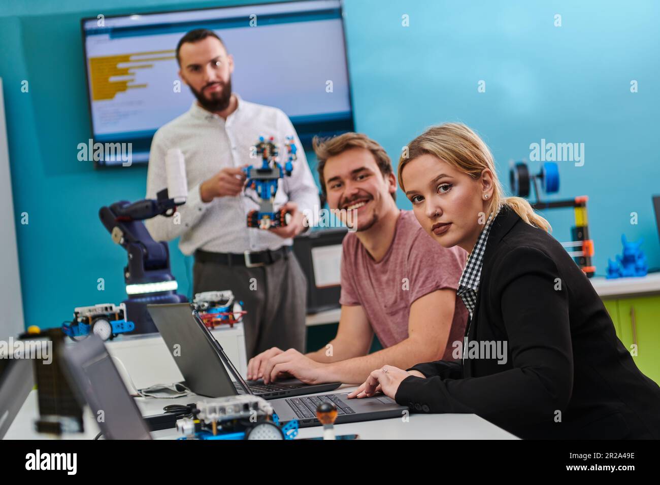 A group of colleagues working together in a robotics laboratory ...