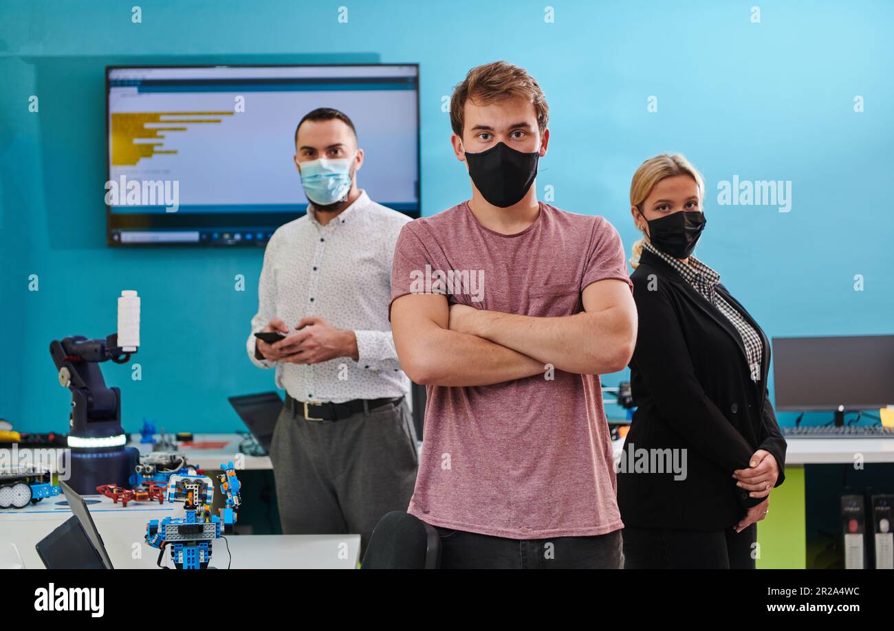 A group of colleagues working together in a robotics laboratory ...
