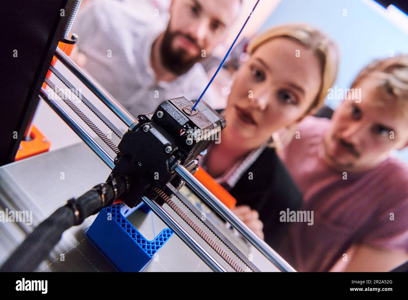 A group of colleagues working together in a robotics laboratory ...