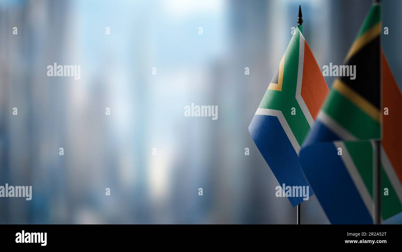 Small flags of the South Africa on an abstract blurry background Stock ...