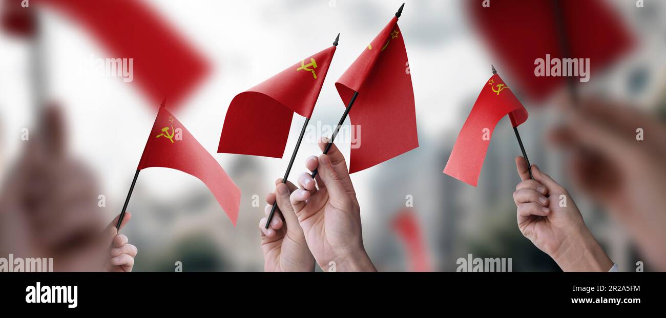 A group of people holding small flags of the USSR in their hands Stock ...