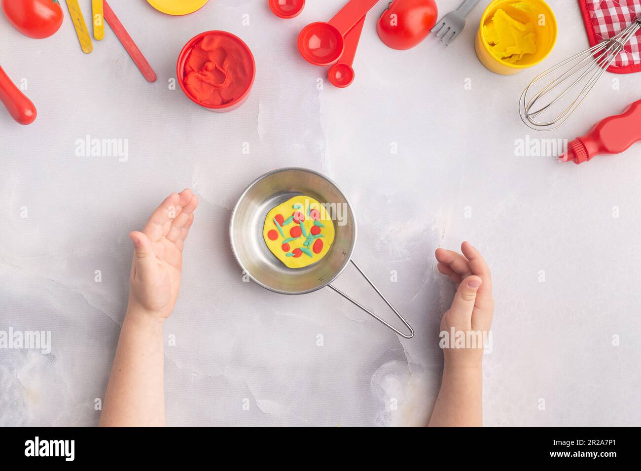 Boy's hands are making pizza with play dough. Kid's plasticine craft ...