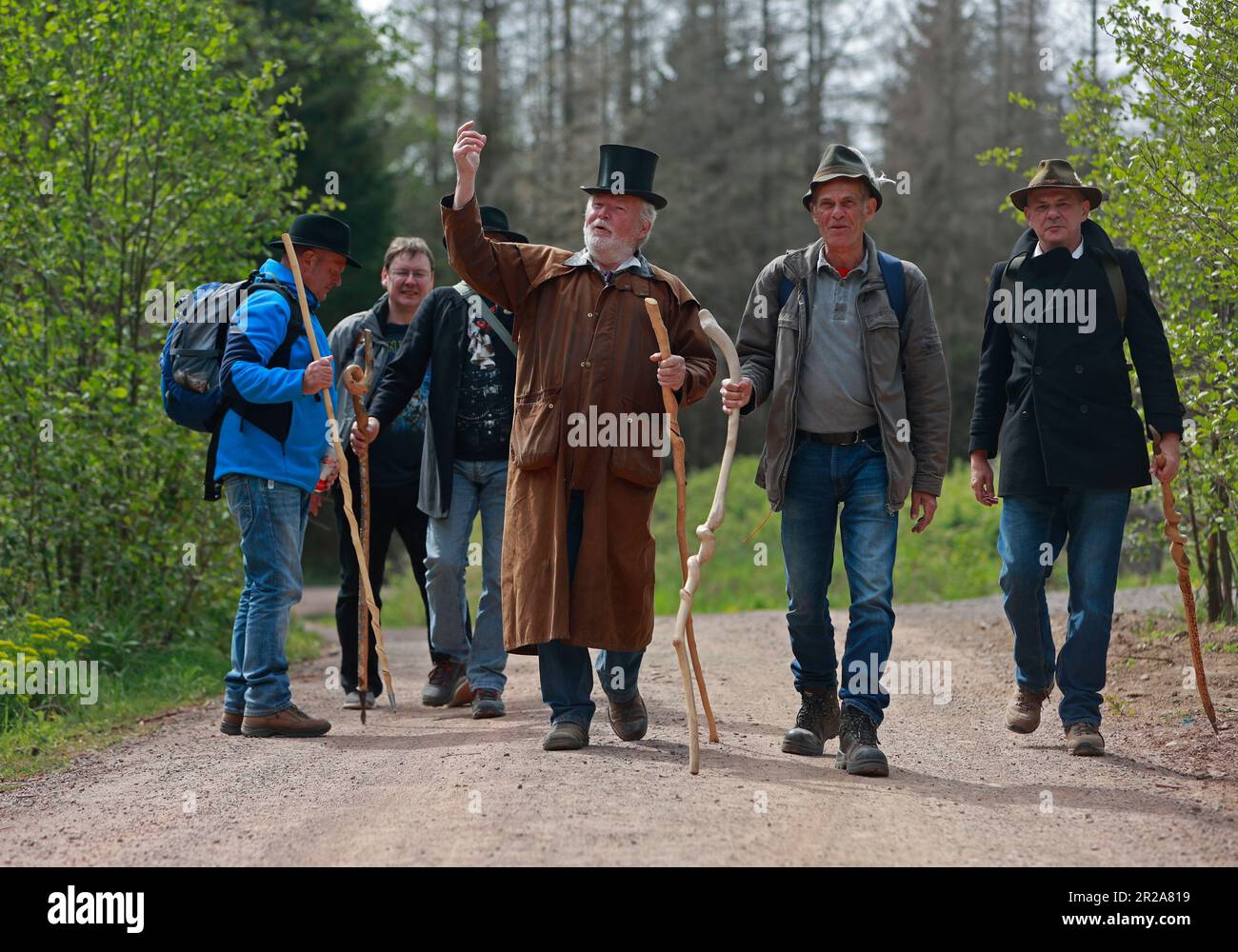 Ilsenburg, Germany. 18th May, 2023. Men in top hats parade through the ...