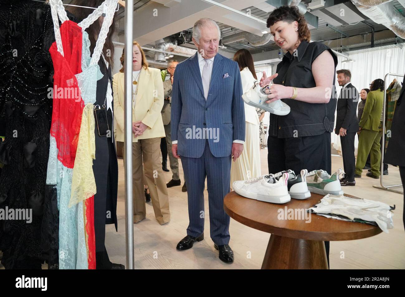 A designer shows King Charles III some trainers, during a special ...