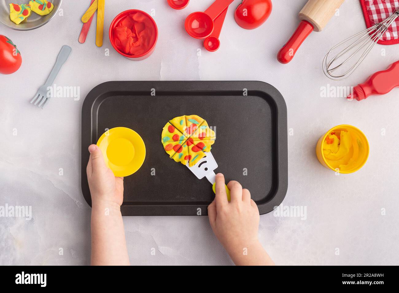 Boy's hands are making pizza with play dough. Kid's plasticine craft ...
