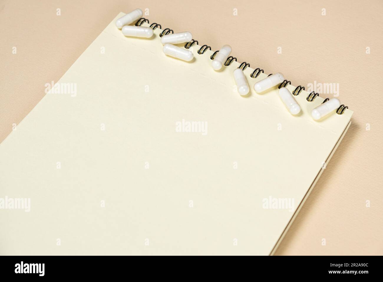 Medical notepad with pills on a beige background, space for text Stock ...