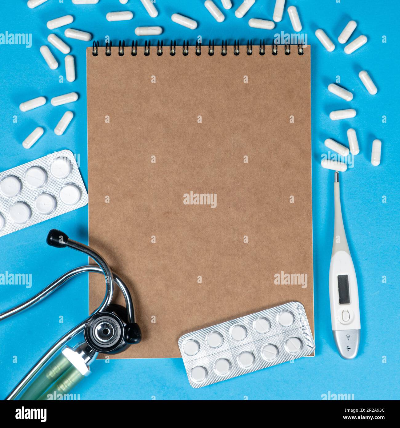 Medical mockup - notepad with stethoscope, pills and thermometer, top ...