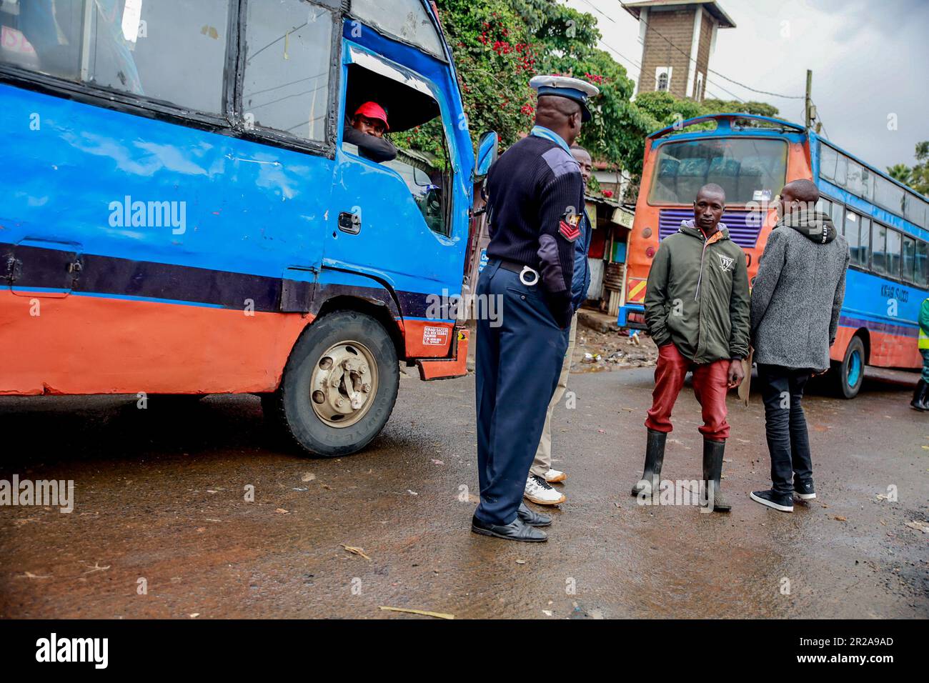 A traffic police officer speaks to motorists at Olympic bus station in ...