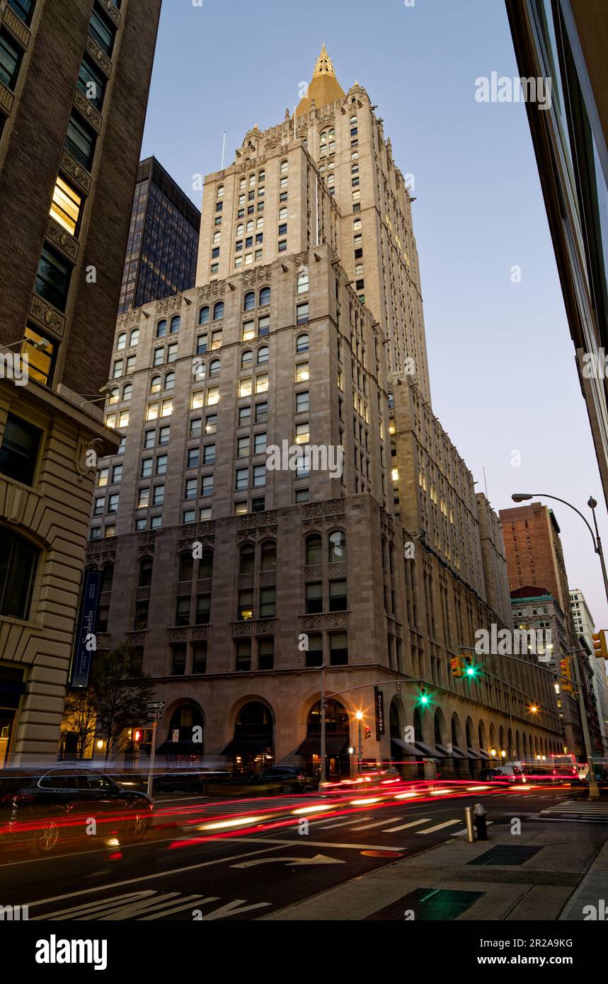 Early morning traffic leaves light trails past the New York Life ...