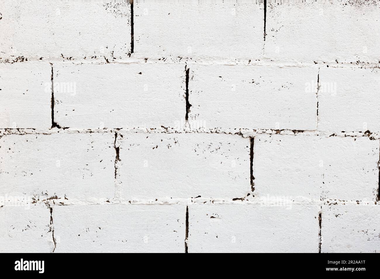 White and rough structure made with blocks. The wall looks old and ...