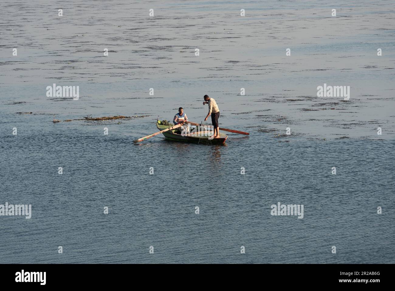 Egyptian fishermen fishing from a small boat on the River Nile at the ...