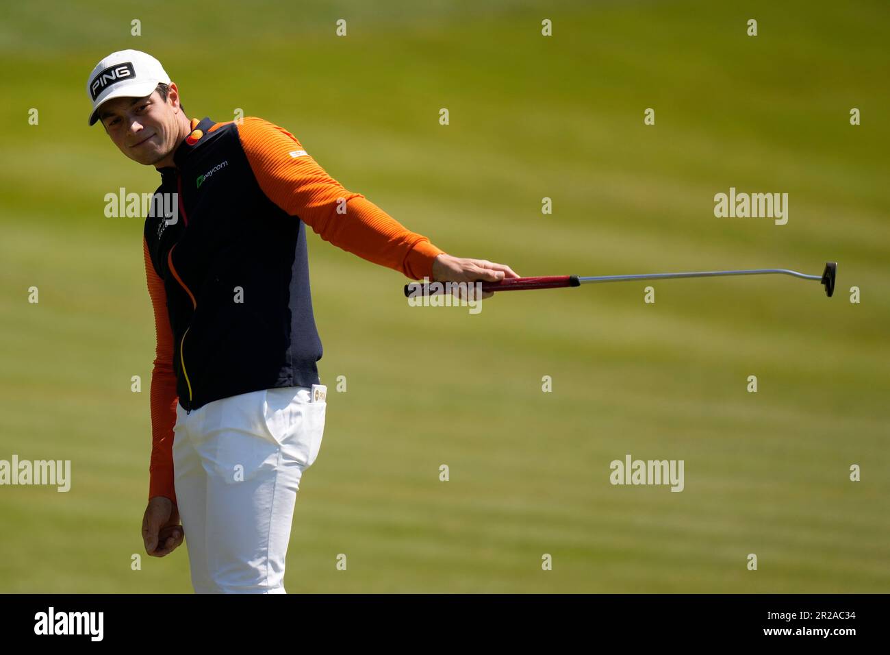 Viktor Hovland, of Norway, reacts after missing a putt on the 14th hole ...