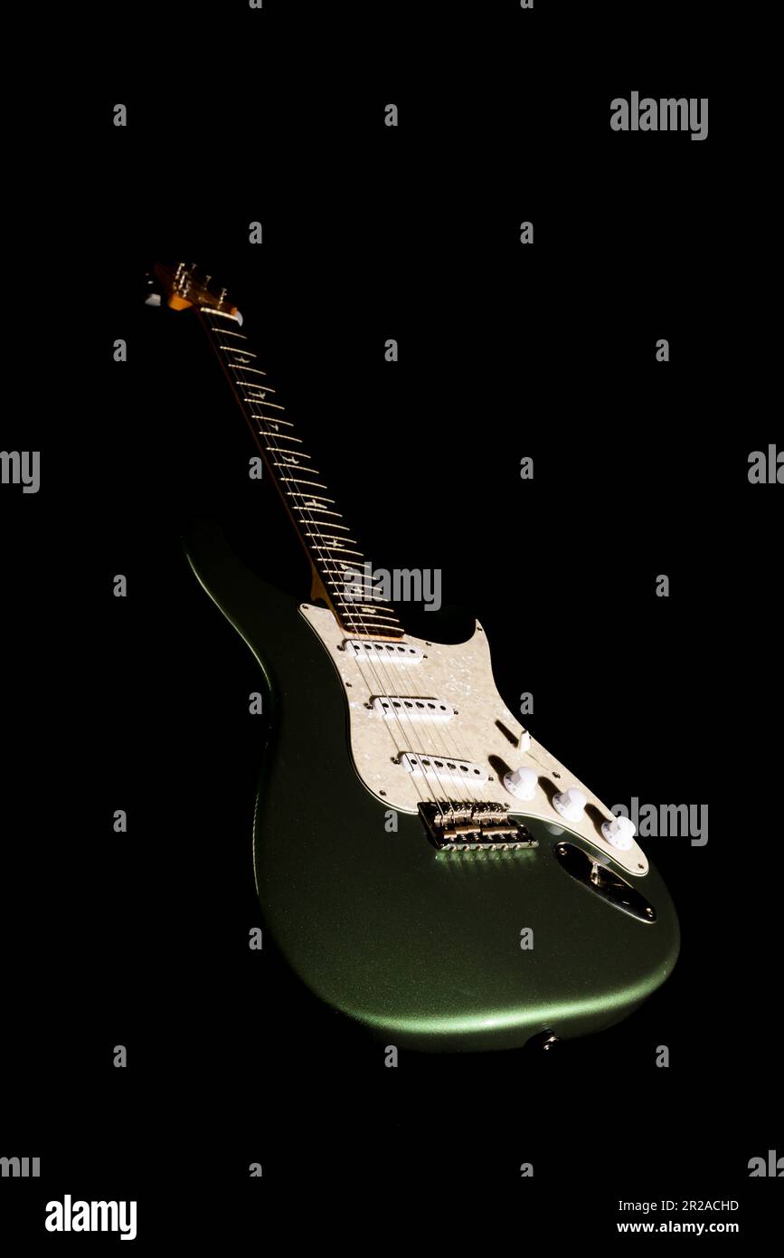 Stratocaster style electric guitar floating on black background Stock ...
