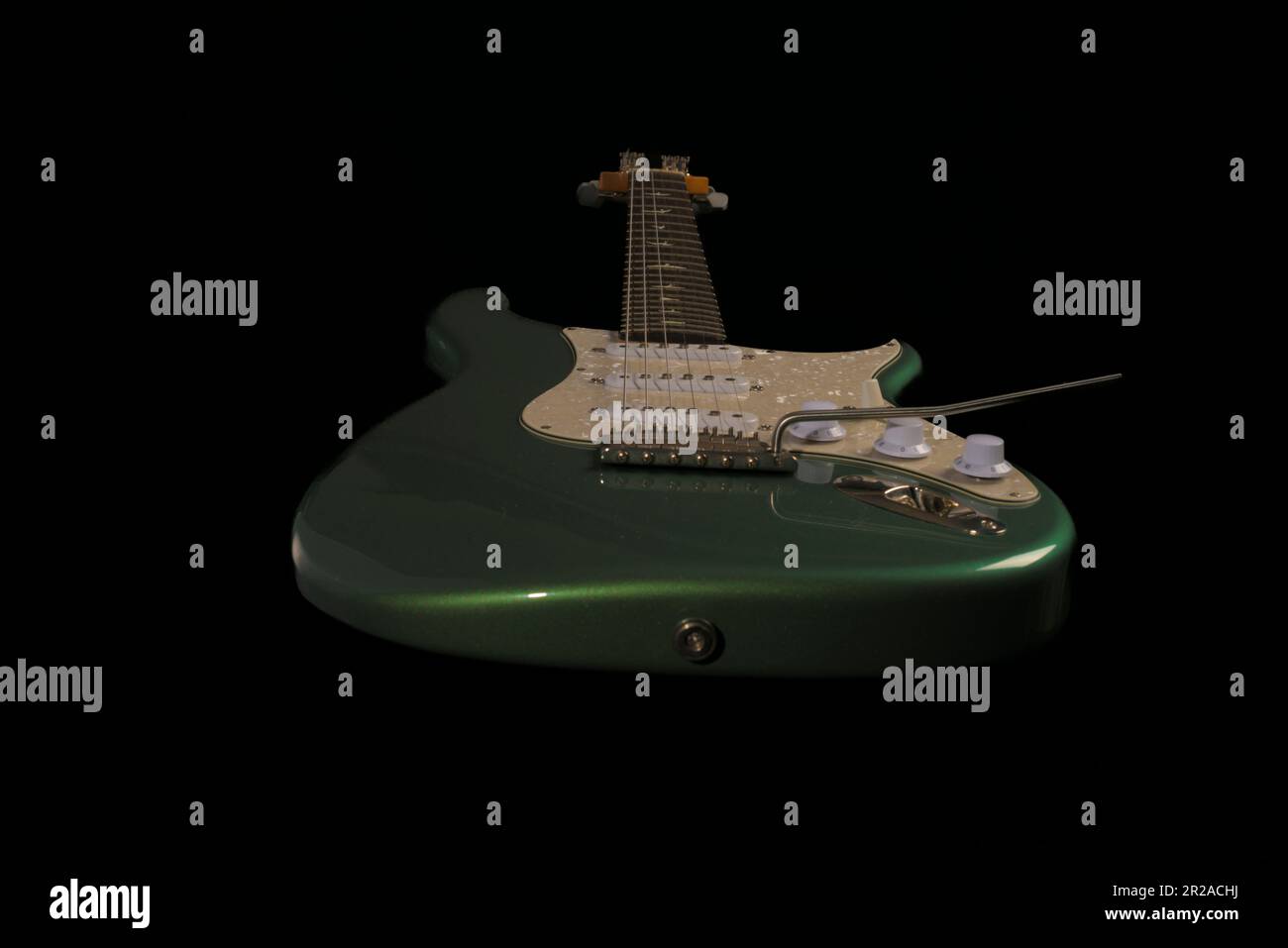 Stratocaster style electric guitar floating on black background Stock ...