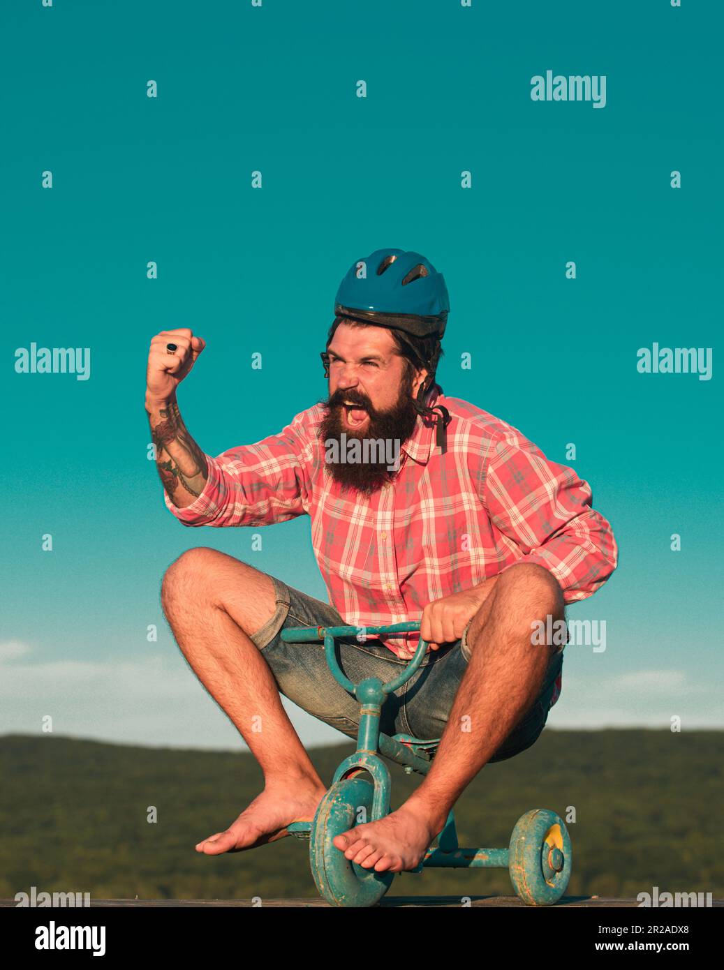 Funny man riding a small bicycle. Guy riding childs tricycle Stock ...