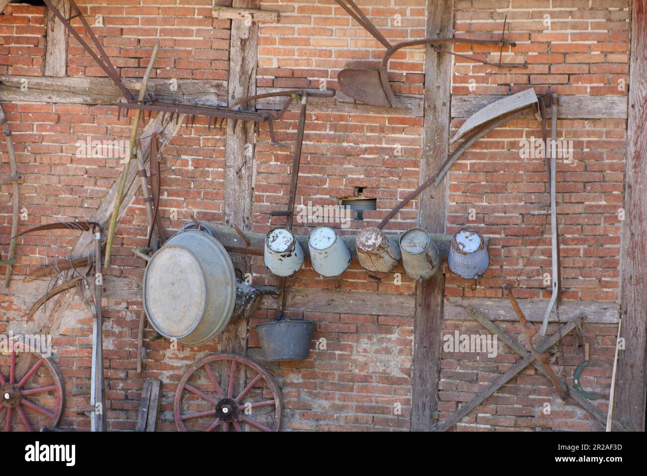 vintage buckets and trough installed at a brick wall Stock Photo - Alamy