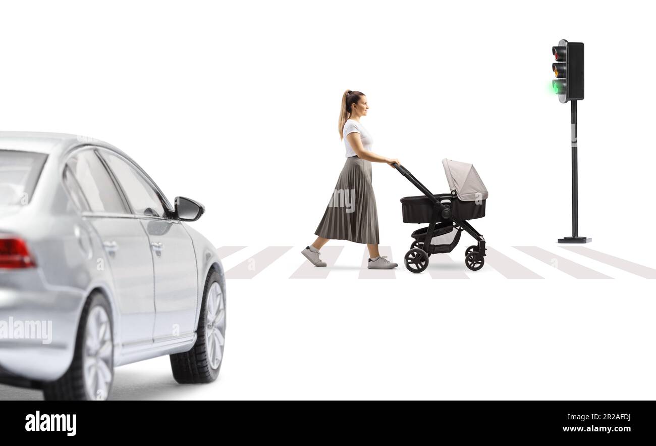 Car at pedestrian crossing and a mother pushing a stroller and crossing ...